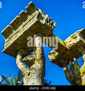 Egyptian statues lifting big boulders written with hieroglyphs at ...
