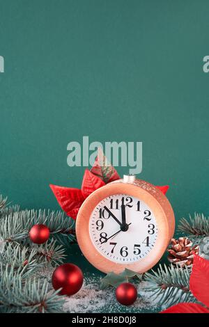 Alarm clock with Christmas balls and fir branches on dark wooden ...