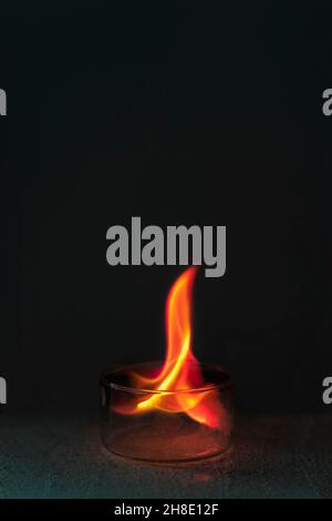 Lithium flame test. Metal salt being sprayed in mist form into a bunsen ...