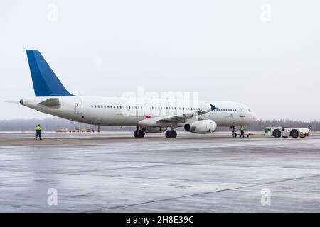 Commercial passenger airplane during push back operation. Shiny metal ...