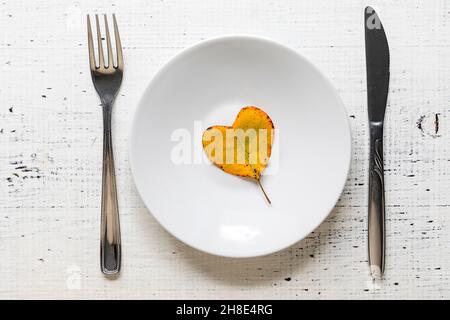 Wooden board with white plate, fork and napkin on grunge beige ...