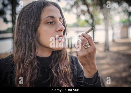 Young female addict smoking heroin at home Stock Photo - Alamy