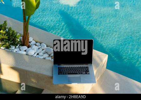 a laptop on the deckchair in swimming pool Stock Photo - Alamy