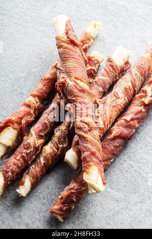 Dog treat sticks. Chewy sticks for dog on wooden table. Top view Stock ...