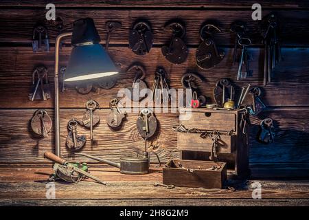 Old locksmiths workplace with locks and tools. Forgotten locksmiths ...