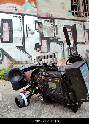 A professional camera on a tripod placed on a coastline shooting the ...