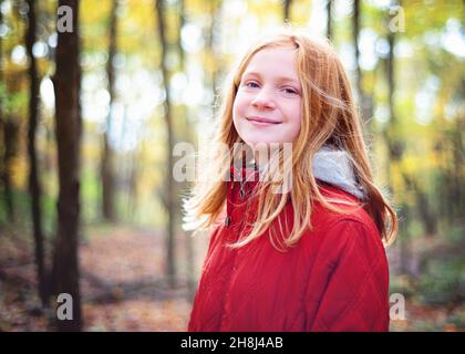 Red Haired Tween Girl Hiking in the Fall woods Stock Photo - Alamy