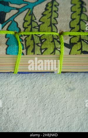 Closeup shot cover of book of sheets bound by hand with woven thread ...
