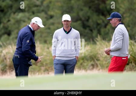 Adam Scott, of Australia, tosses his ball on the first hole during the ...