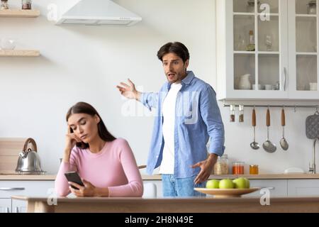 Upset man with screaming wife during celebration of Christmas Stock ...