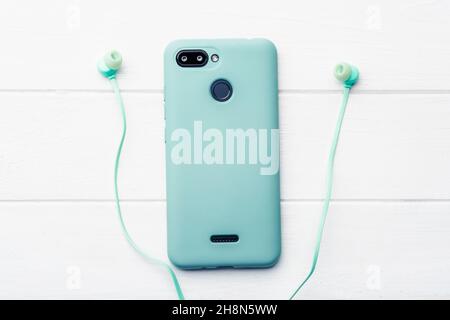 Digital telephone with protection and headphones at the table, close-up ...