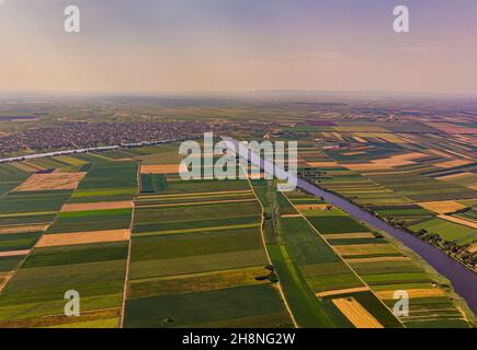 Birds-eye view of land and the Tisa river flowing through it in Serbia ...