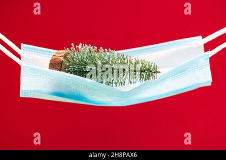 surgical mask as hammock with christmas tree Stock Photo - Alamy
