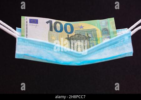 surgical mask as hammock with 100 euro banknotes Stock Photo - Alamy