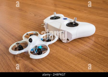 small white indoor home brushless fpv quadcopter Stock Photo - Alamy