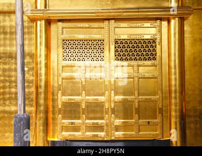 Doors at Shinto shrine in Tokyo, Japan. Name plate of the shrine above ...