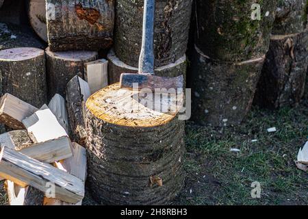 an ax in a hemp on logs background Stock Photo - Alamy
