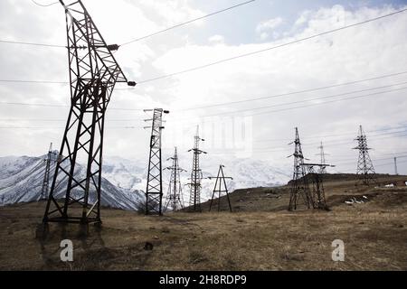 High voltage post with transmission towers Stock Photo - Alamy
