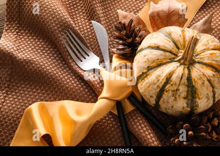 Beautiful table setting with pine cone and fir branches on white wooden ...