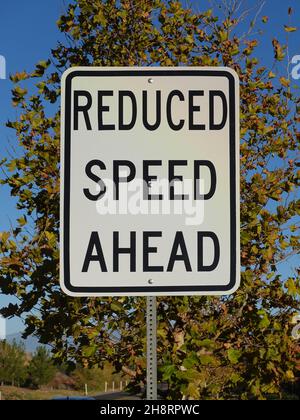 speed reduced ahead road sign with blue sky background Stock Photo - Alamy