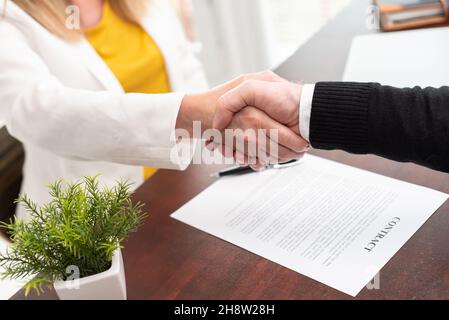 Businesswoman and businessman shaking hands (lorem ipsum text used ...