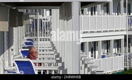A couple walks by the Ocean House hotel where a temporary event tent ...