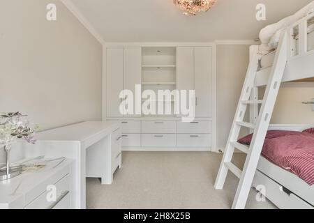 Children bunk bed with wooden ladder placed near window in light ...