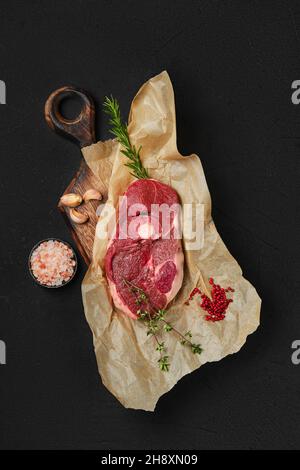 Raw lamb center cut leg steak with spice on wrapping paper Stock Photo ...
