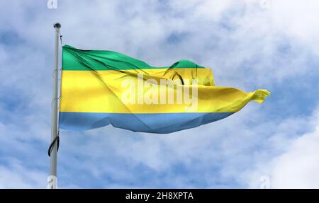 Waving Gabon flag in the sunny blue sky with summer beach background ...