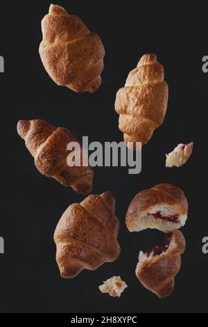 Falling delicious fresh baked croissants on white background. French ...