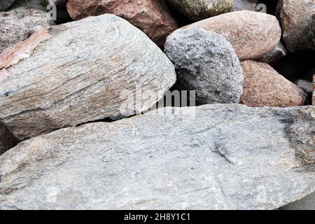 Rockfall on the road in the mountains. Stones of different sizes ...