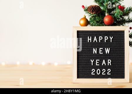 Happy new year 2022 greetings on letter board with holiday lights and ...