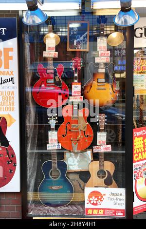 Guitar and other musical instrument shops and stores line both sides of ...