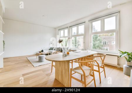 Comfortable sofa and dining table with soft cushions located in ...