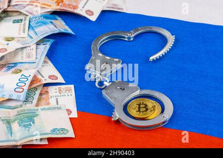 bitcoin shiner chained with handcuffs on russian flag background ...