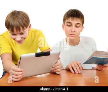 Comparison of a tablet and a book isolated on white. Battery life ...