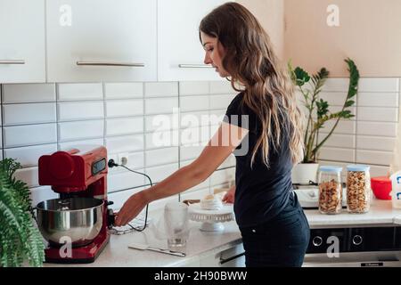 woman cooks delicious sweet desserts cakes in the kitchen Stock Photo ...