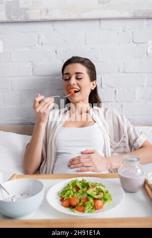 Young woman holding bowl with oatmeal in hands Stock Photo - Alamy