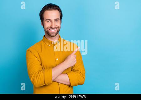 Photo of reliable man direct finger empty space promote sale wear green ...