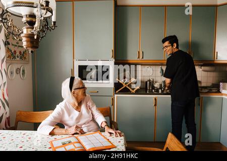 Asian healthcare worker talking on phone in bright modern office ...