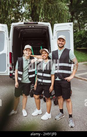 Side view portrait of female delivery driver using smartphone app in ...