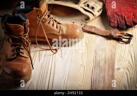 Leather tool belt protective gloves on concrete background Stock Photo ...