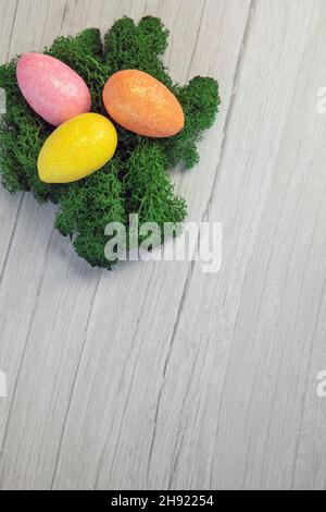 Happy Easter holliday concept, colorful easter eggs with green moss on ...