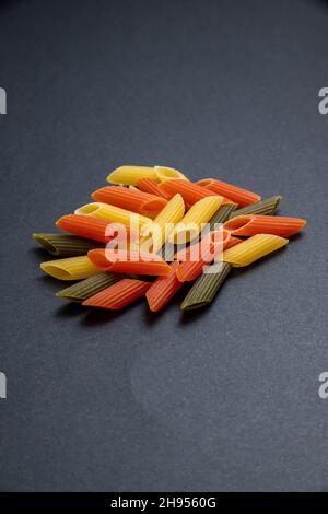 Traditional italian colored pasta penne with cherry tomatoes and lots ...