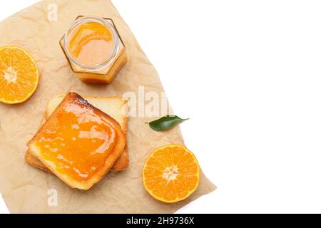 Parchment with jar of tasty tangerine jam on light background Stock ...