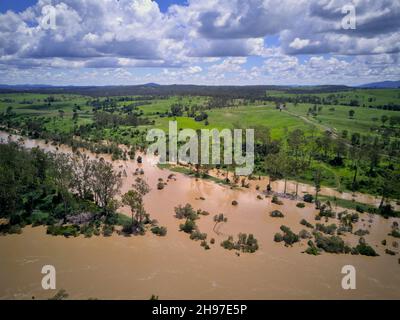 Aerial of the Burnett river in flood Dec 2021 covering highway bridge ...