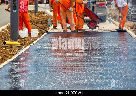 Melting asphalt with paver machine and placing gravel. Asphalt pavement ...