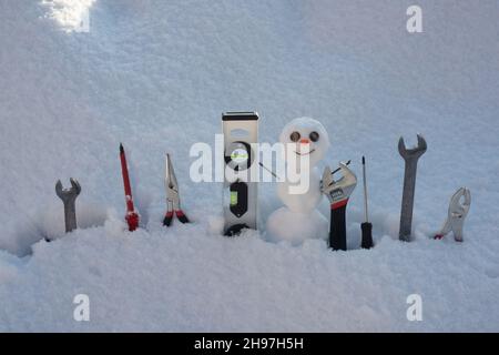 Snow man. Repairman with repair tools. Support repair and recover ...