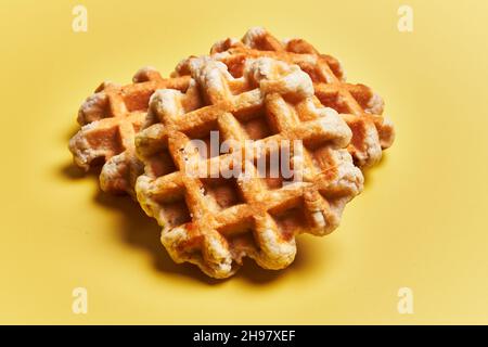 Bunch of delicious waffles over yellow background Stock Photo - Alamy