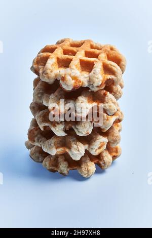 Bunch of delicious waffles over blue background Stock Photo - Alamy